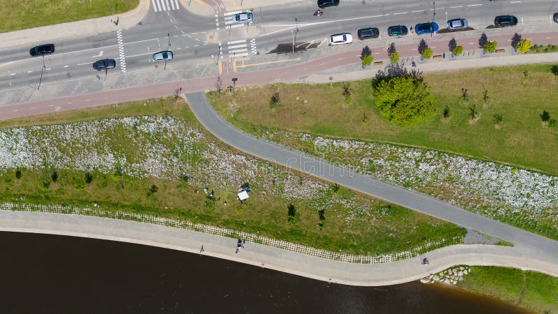 Aerial View of a Riverside Park with a Bike Path, Trees, and a Field of ...