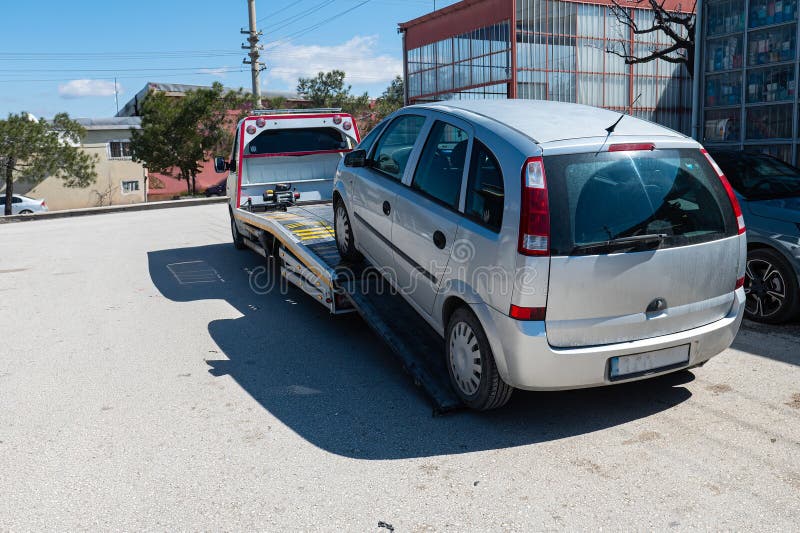 The Defective Car is Unloaded from the Tow Truck Stock Image - Image of ...