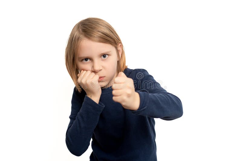 In a Defensive Pose, a Boy of Ten with Flowing Locks Practices Martial ...