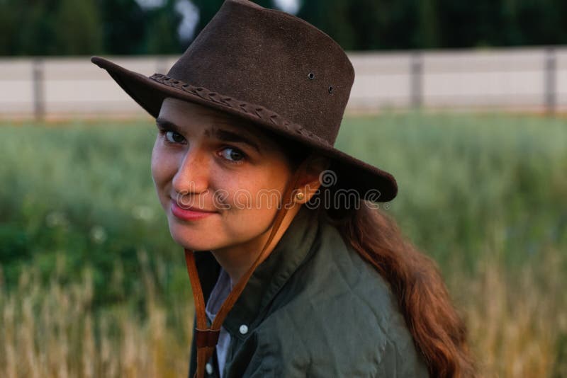 Defocus Portrait Smiling Young Woman in Cowboy Hat. Girl in a Cowboy ... Defocus Portrait Smiling Young Woman in Cowboy Hat. Girl in a Cowboy ...