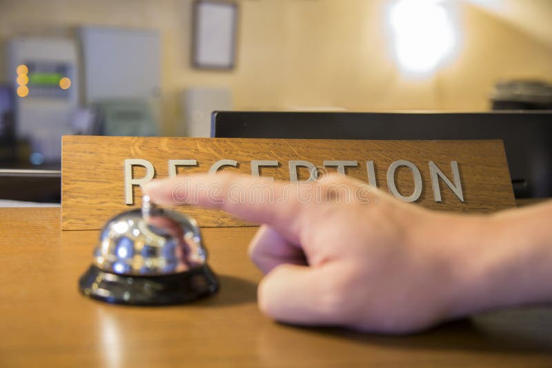 Defocused Hand Using a Bell with Reception Sign Stock Photo - Image of ...