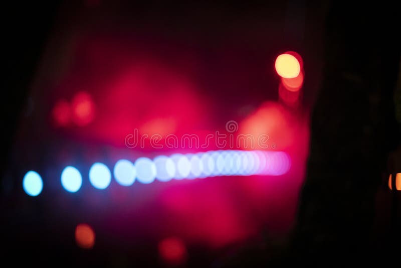 Defocused View of Red Bokeh Lights and Mist Appearing from the Dark ...
