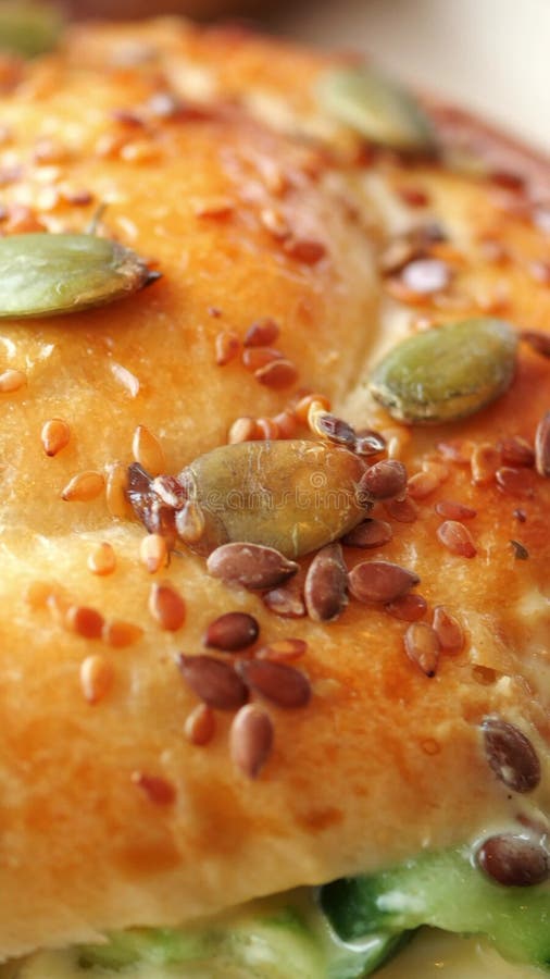 A Freshly Baked Soft Bread Roll Topped with Seeds and Vegetables Stock ...