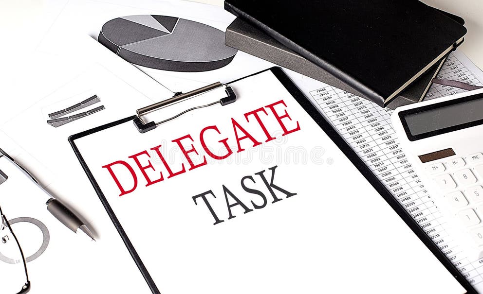DELEGATE TASK Text on Paper Clipboard with Chart and Notebook on Withe ...