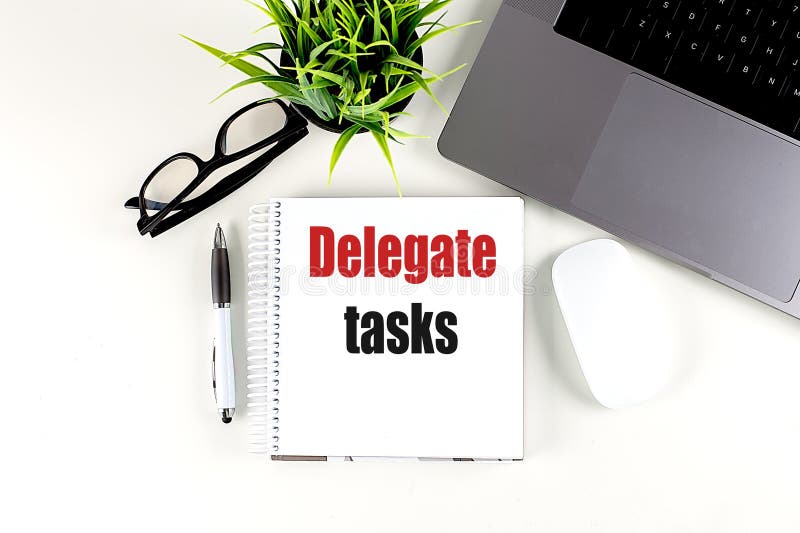 DELEGATE TASKS Text on Notebook with Laptop, Mouse and Pen Stock Image ...