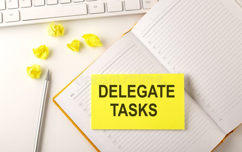DELEGATE TASKS Text on Sticker on the Diary with Keyboard and Pencil ...