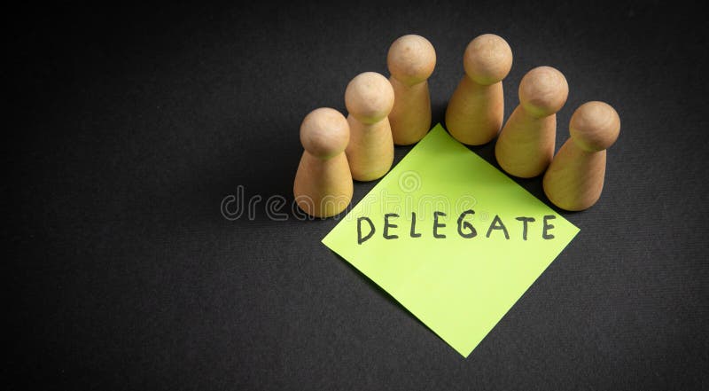 Delegate Word on Sticky Note with a Wooden Human Figures Stock Image ...