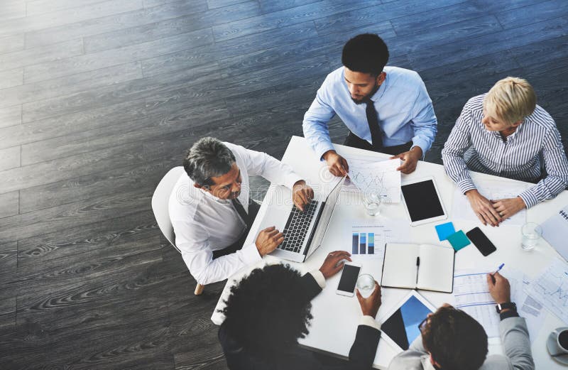 Delegating Tasks Around the Table. a Group of Businesspeople Having a ...