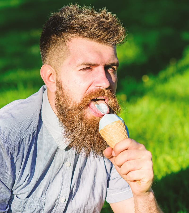 Delicacy Concept Man With Long Beard Eats Ice Cream While Sits On