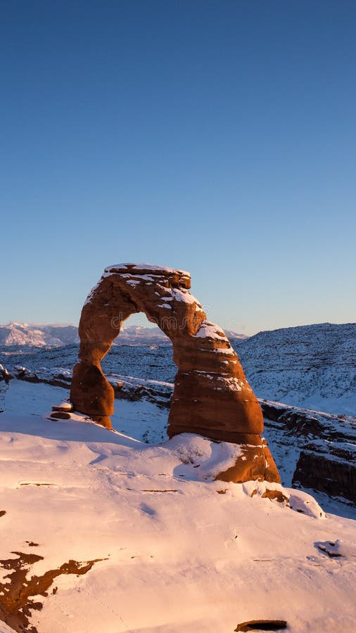 Delicate Arch at Sunset in Winter Stock Photo - Image of freezing ...