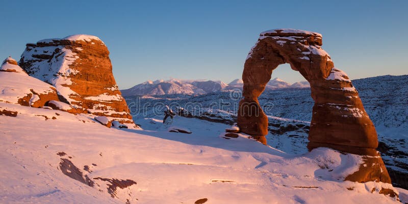 Delicate Arch at Sunset in Winter Stock Photo - Image of colorful ...