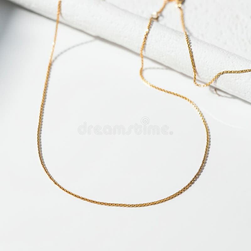 Delicate Gold Chain Necklace Resting on a Smooth White Surface. Its ...