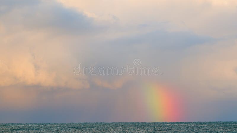 Delicate Rainbow Over the Ocean. Beautiful Rainbow Over the Stormy Sea ...