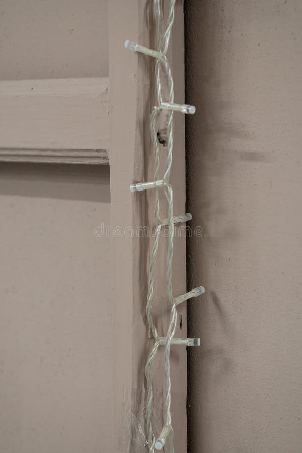 Delicate String Lights Adjacent To a Light-Colored Wall Stock Image ...