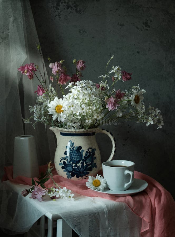 Delicate White Flowers Arranged in a Vintage Pitcher Sitting on a ...