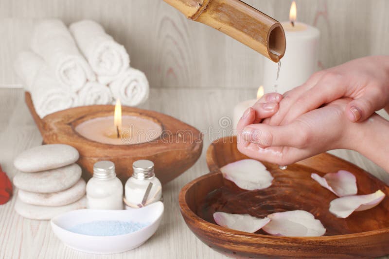 Delicate Young Hands Under the Stream of Water from the Bamboo Stem ...