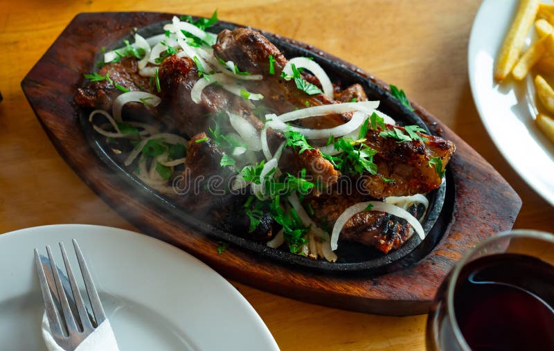 Delicious Beef Steak with Fried Onions on Dining Table Stock Photo ...