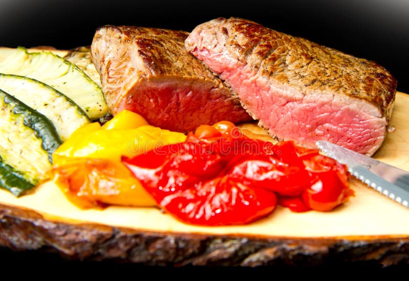 Delicious Beef Steaks on Wooden Table Stock Photo - Image of rare ...
