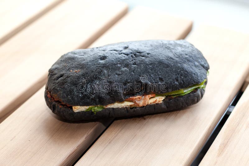 Delicious Black Sandwich on Wood Table. Closeup Stock Photo - Image of ...