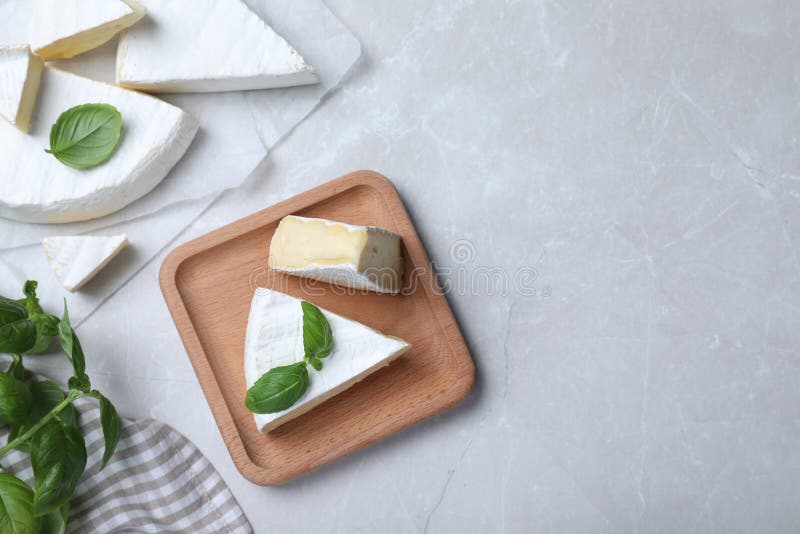 Delicious Brie Cheese with Basil on Grey Table, Flat Lay. Space for ...