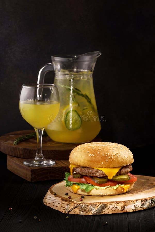 Delicious Burger with Fried Onion Rings and a Glass of Lemonade Stock ...