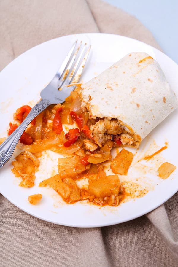 Delicious Burrito with Meat, Beans, and Vegetables on a Cutting Board ...