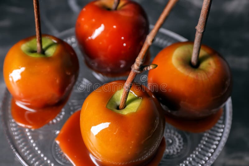 Delicious Caramel Apples with Tree Branches on Glass Stand Stock Image ...