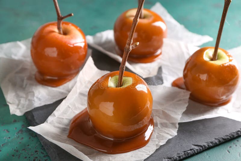 Delicious Caramel Apples with Tree Branches on White Background Stock ...