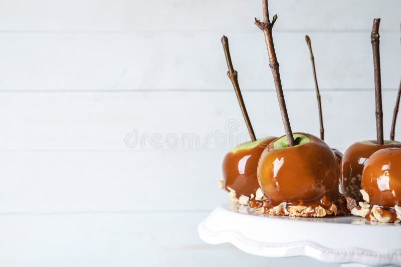 Delicious Caramel Apples with Tree Branches on Stand Stock Photo ...