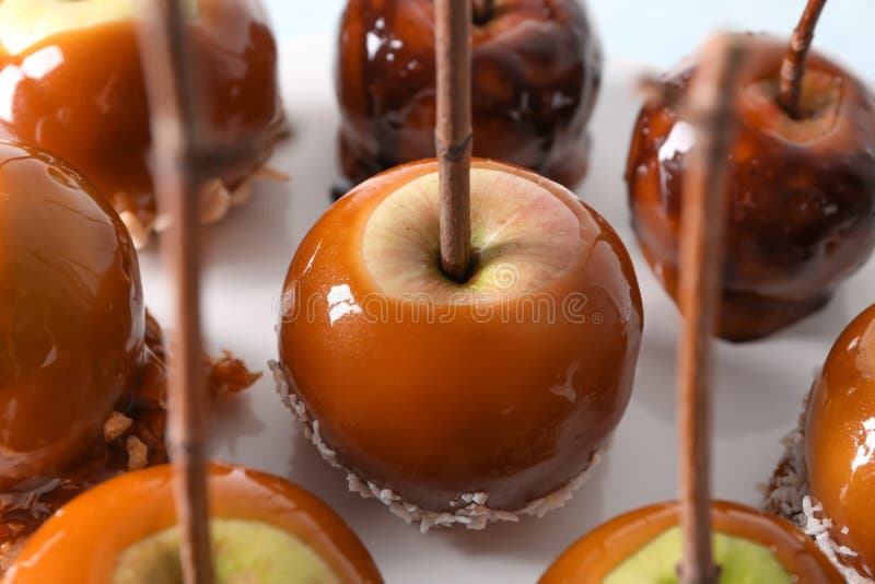 Delicious Caramel Apples with Tree Branches on Stand, Closeup Stock ...