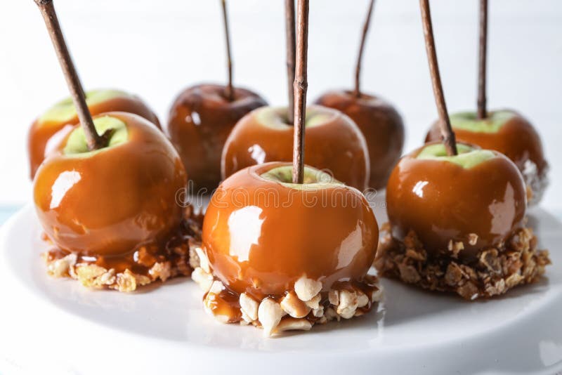 Delicious Caramel Apples with Tree Branches on Stand, Closeup Stock ...