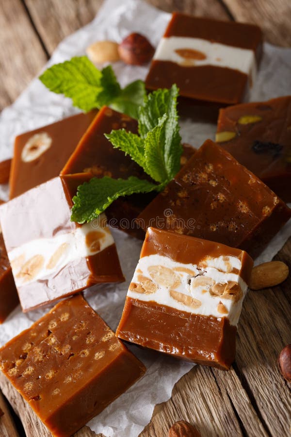 Delicious Caramelized Toffee with Nuts Close-up on Parchment. Vertical ...