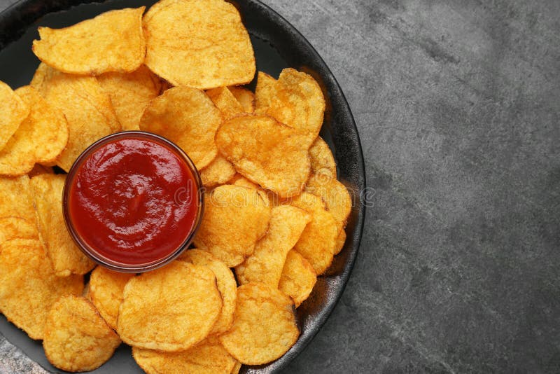 Delicious Chips with Ketchup on Grey Table, Top View. Space for Text ...