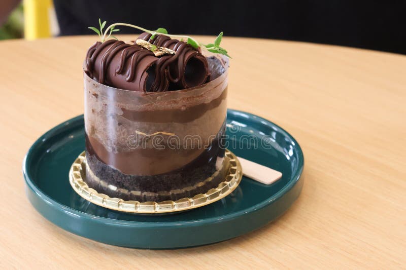 Delicious Chocolate Cake in Ceramic Plate on Dining Table in Cafe ...