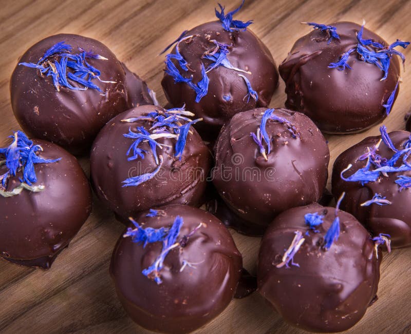 Delicious Chocolate Candies on Wooden Table Stock Photo - Image of ...