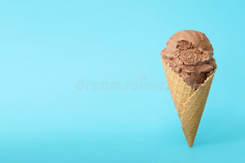Delicious Chocolate Ice Cream in Waffle Cone on Light Blue Background ...