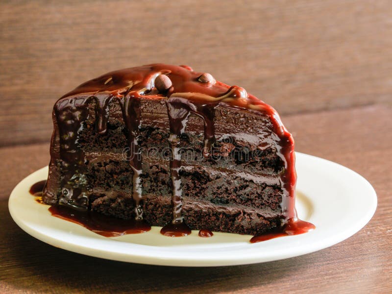 Delicious Chocolate Layer Cake on Plate on Wooden Table Stock Photo ...
