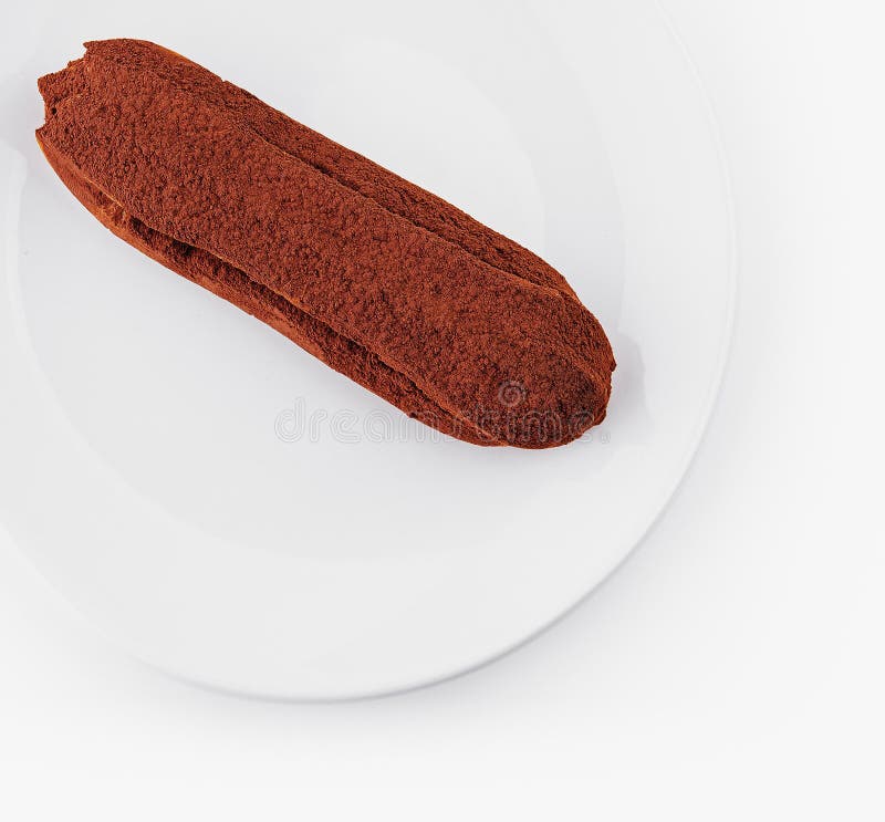 Delicious Classic Chocolate Eclair on White Plate Stock Photo - Image ...