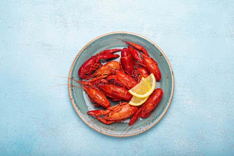 Delicious Cooked Crayfish with Lemon Slices on Rustic Blue Plate Top ...