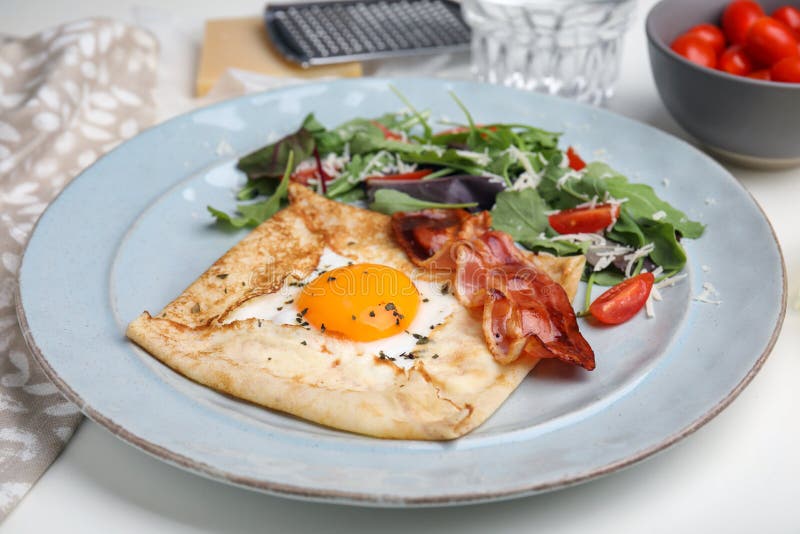 Delicious Crepe with Egg on White Table. Breton Galette Stock Image ...