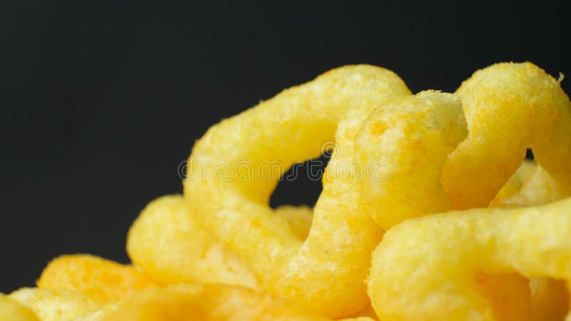 Delicious Crispy Corn Chips with Spices Spin in a Circle on a Black ...