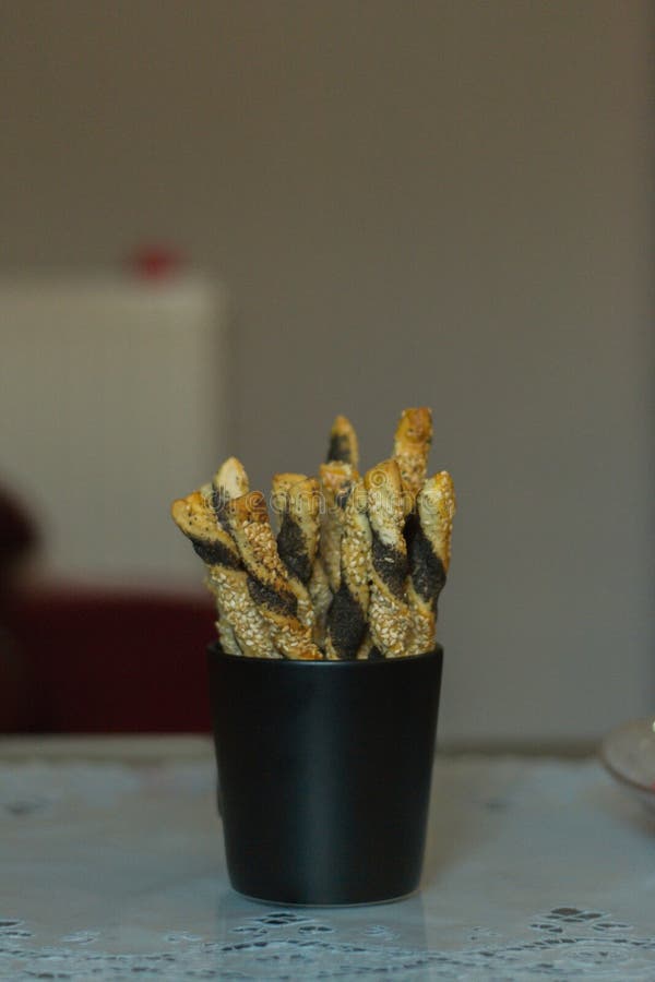 Delicious Crunchy Breadsticks Coated with Sesame Seeds in a Black ...