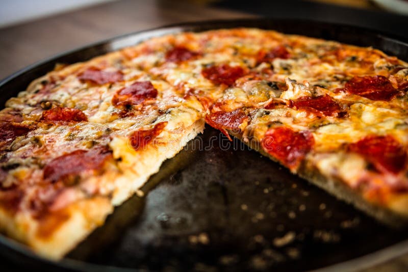 Delicious Cut Pizza in a Large Round Plate Stock Photo - Image of food ...