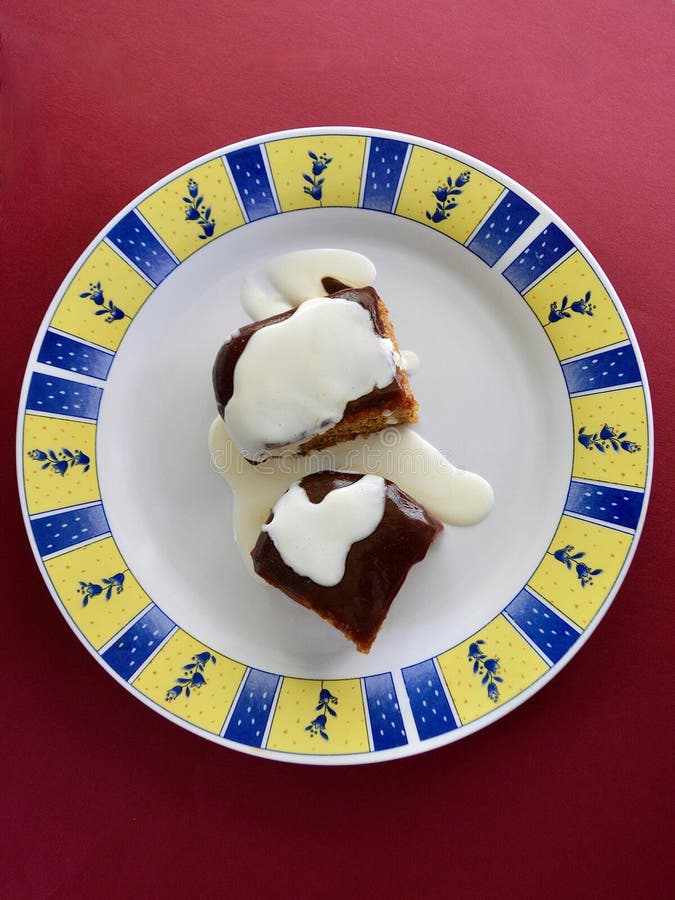 Sticky Date Pudding a Plate with a Drizzle of Thickened Cream. Stock ...