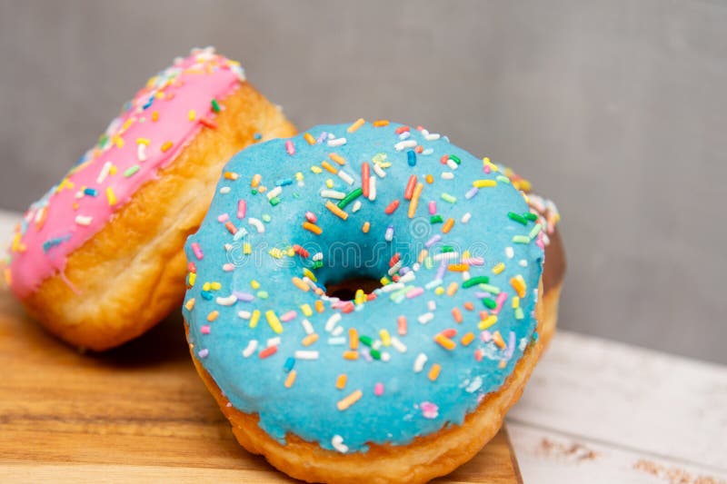 Delicious Dessert. Pink, Blue and Chocolate Donuts with Multicolored ...