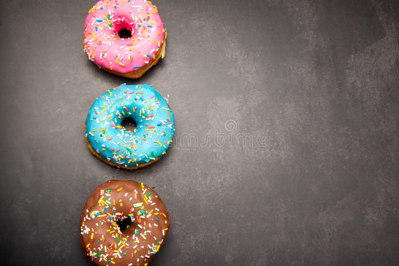 Delicious Dessert. Pink, Blue and Chocolate Donuts with Multicolored ...