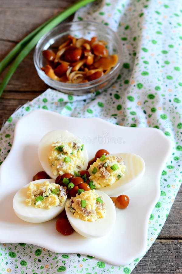 Delicious Deviled Eggs on a Plate. Boiled Eggs Stuffed with Grated Cheese, Marinated Mushrooms ...