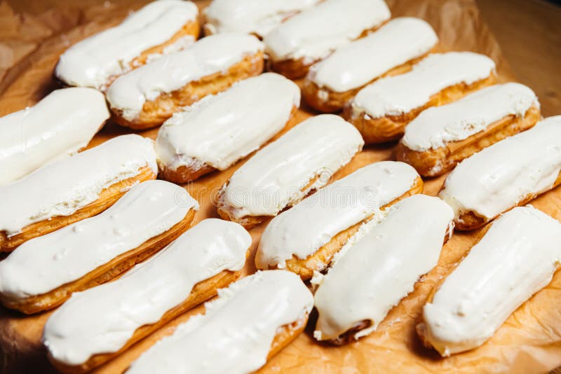 Delicious Eclairs with White Frosting on a Craft Paper Stock Photo ...