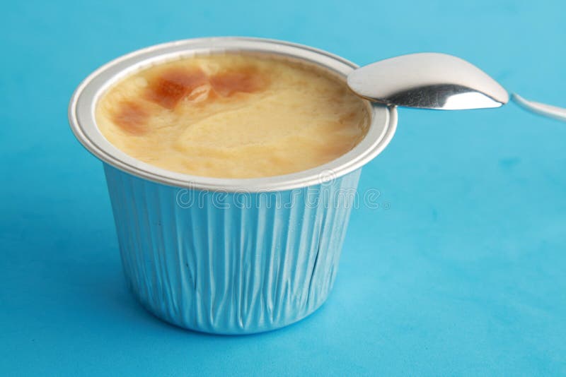 Delicious Egg Flan in an Aluminum Container and a Spoon on a Blue ...