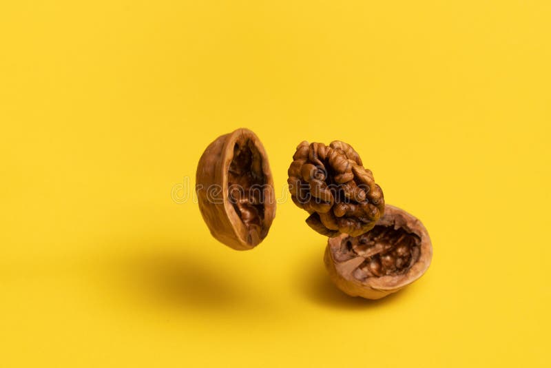 Delicious Flying Walnut on Yellow Background. Stock Photo - Image of ...